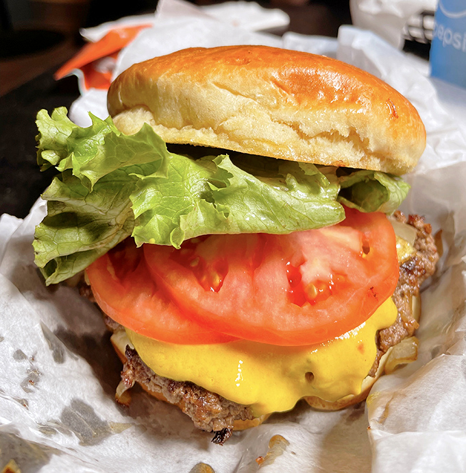 Behold the cheeseburger in its natural habitat &ndash; juicy patty, melted cheese, fresh veggies, all nestled in a perfectly toasted bun. Simple. Perfect. Wisconsin.