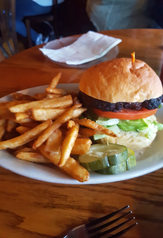A burger that demands a two-handed commitment, with fries standing at attention like they know they're part of something special.