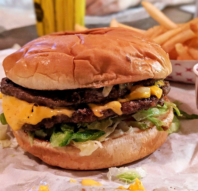 This isn't just a burger; it's a masterclass in balance—charred beef, melty cheese, fresh veggies, and a bun that knows its supporting role perfectly.