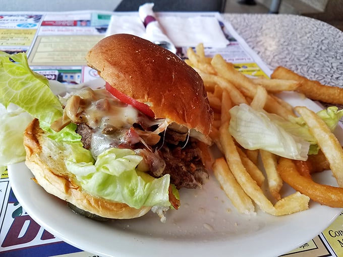 The burger—architecture you can eat! Notice how that melty cheese cascades down the side like delicious lava, while those fries stand at attention.