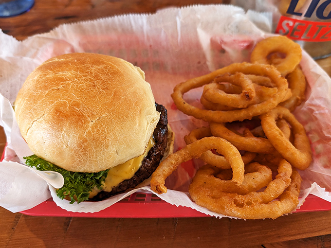 A burger that requires both hands and a strategy, paired with onion rings that shatter with each bite. Fast food's sophisticated cousin.