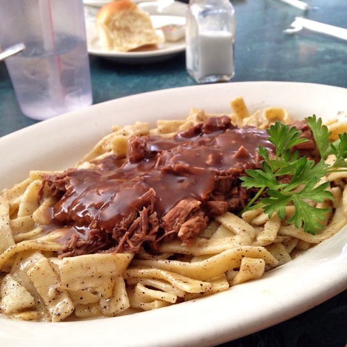 Buttered noodles cradle slow-cooked beef like a carbohydrate hammock for meat that's clearly been cooking since yesterday. The parsley adds a touch of "see, it's fancy."