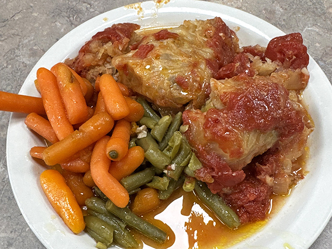Grandma-approved cabbage rolls swimming in savory sauce alongside perfectly cooked vegetables&mdash;the kind of plate that makes you want to hug the chef.