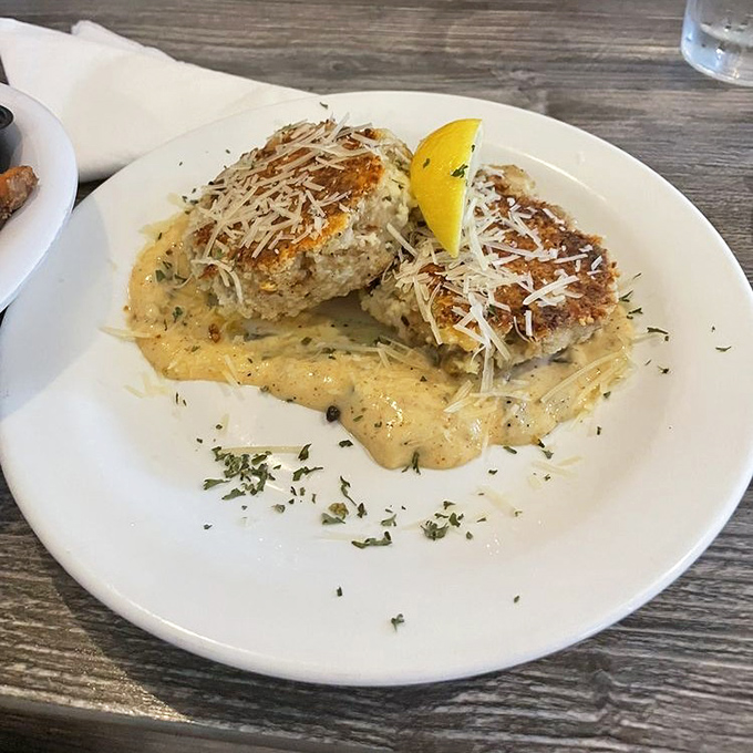 These crab cakes aren't just golden-brown, they're practically auditioning for the seafood hall of fame, served with a sauce that deserves its own fan club.