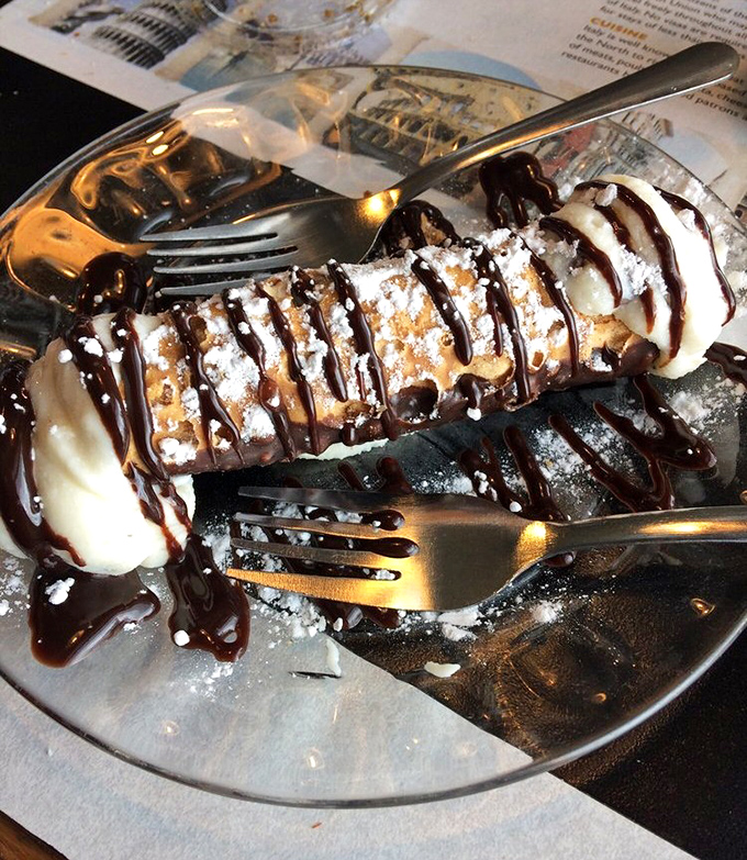 That cannoli's chocolate drizzle pattern could hang in a museum, but it belongs in your belly.