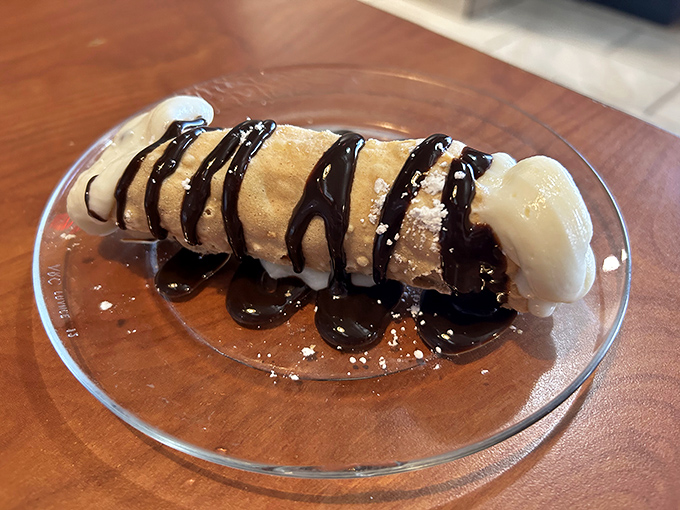 The cannoli shell maintains that crucial crispness while chocolate sauce zigzags across the top like an Italian expressway.