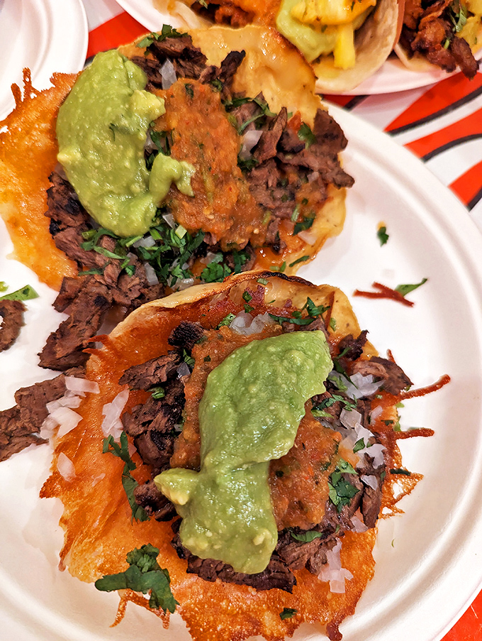 Crispy-edged carne asada tacos with vibrant green guacamole&mdash;proof that sometimes the simplest combinations create the most profound flavors.