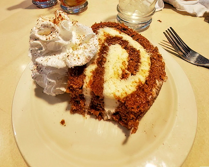 Carrot cake that doesn't skimp on the good stuff—a perfect spiral of cream cheese frosting that makes you wonder why anyone would ever eat carrots any other way.