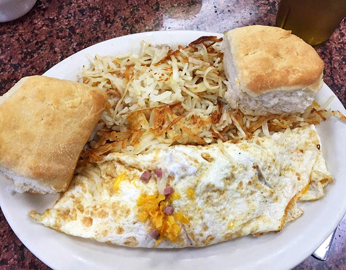 Breakfast of champions: a fluffy omelet with hash browns and homemade biscuits. The plate that launched a thousand road trips.