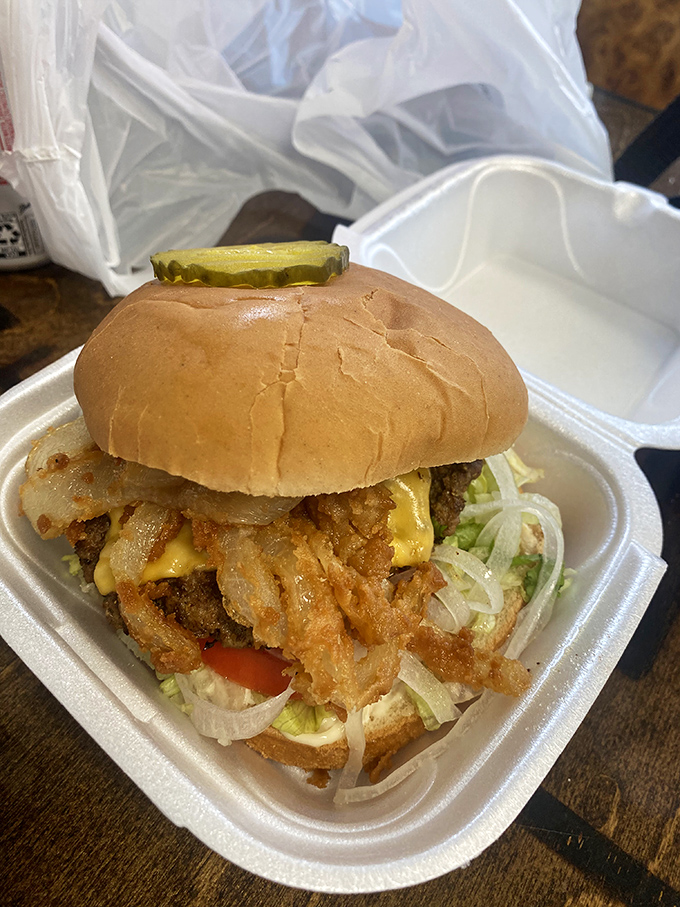 A burger so perfectly constructed it deserves its own architectural award – the melted cheese creating that golden seal of approval.