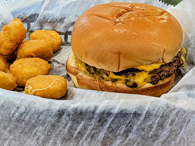 A proper American cheeseburger with tater tots—no foam, no tweezers, no nonsense. Just honest-to-goodness satisfaction on a bun.