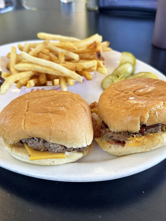 Two sliders, perfectly proportioned for maximum enjoyment. The cheese melts just right, making each bite better than the last.