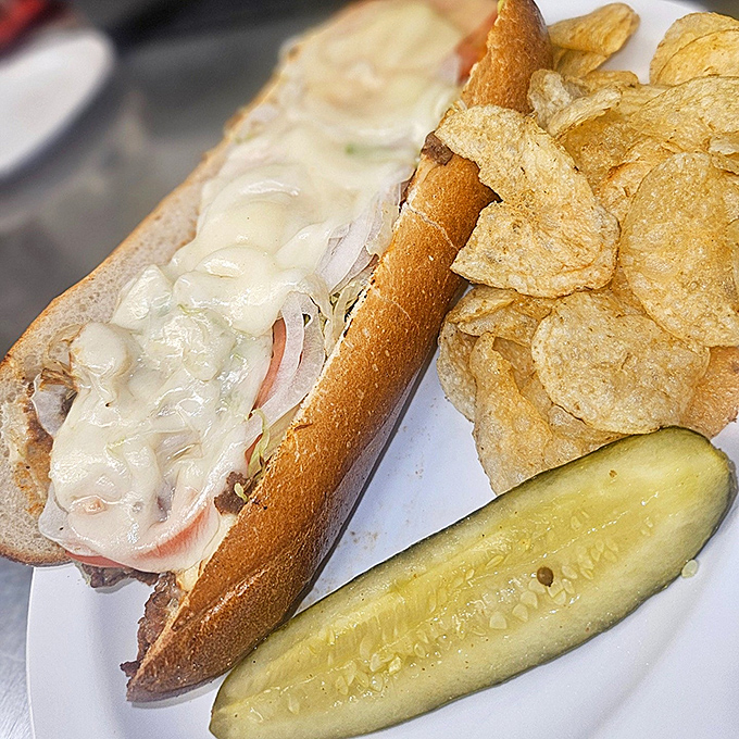 Melted cheese cascades over thinly sliced beef on a proper roll&mdash;Pottsville's contribution to sandwich perfection served with chips and a pickle. 