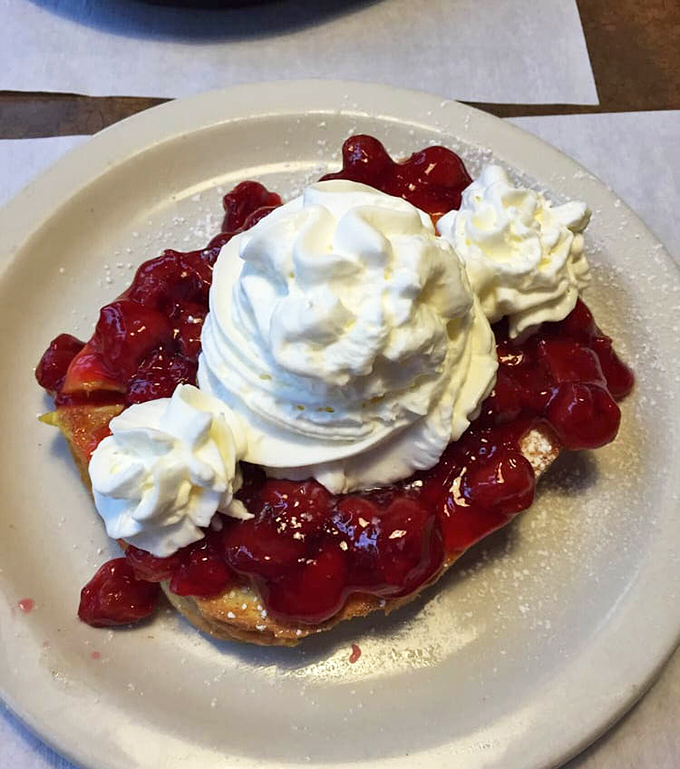 Cherry-topped French toast arrives like dessert's sophisticated cousin who went to culinary school first.