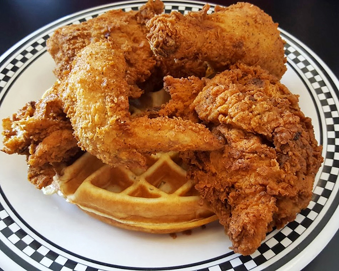 Golden-fried chicken perched atop a waffle like it's the throne it deserves &ndash; the ultimate sweet-savory monarchy on a plate.