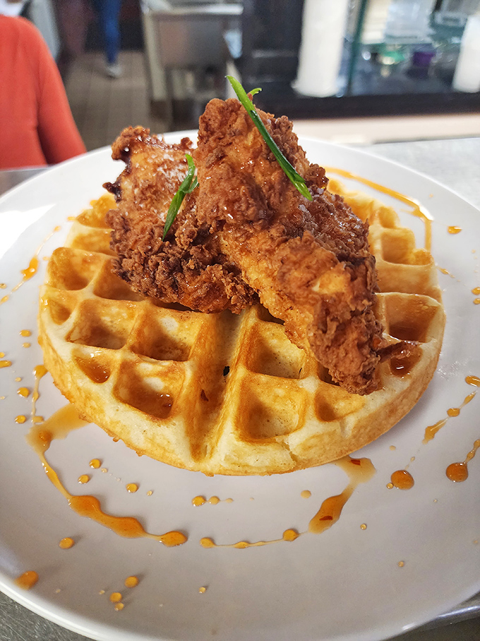 Chicken and waffles: the breakfast equivalent of a power couple, where crispy meets fluffy in a relationship drizzled with sweet-spicy sauce that just works.