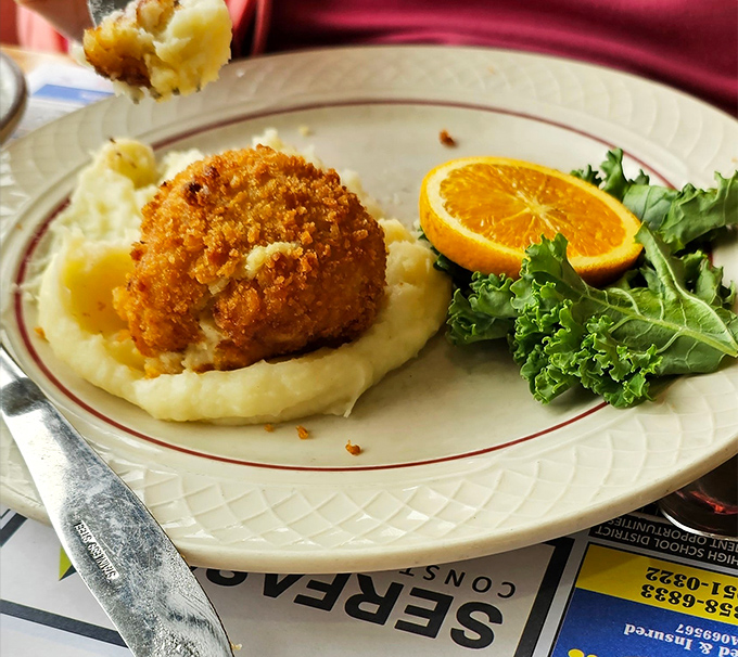 This chicken croquette perched atop cloud-like mashed potatoes isn't just food—it's edible nostalgia, a taste of Pennsylvania comfort in its purest form.