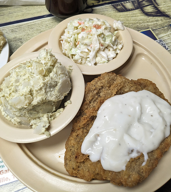 Country fried steak with white gravy alongside potato salad and coleslaw &ndash; a Southern trinity that could convert even the most devoted health nut.