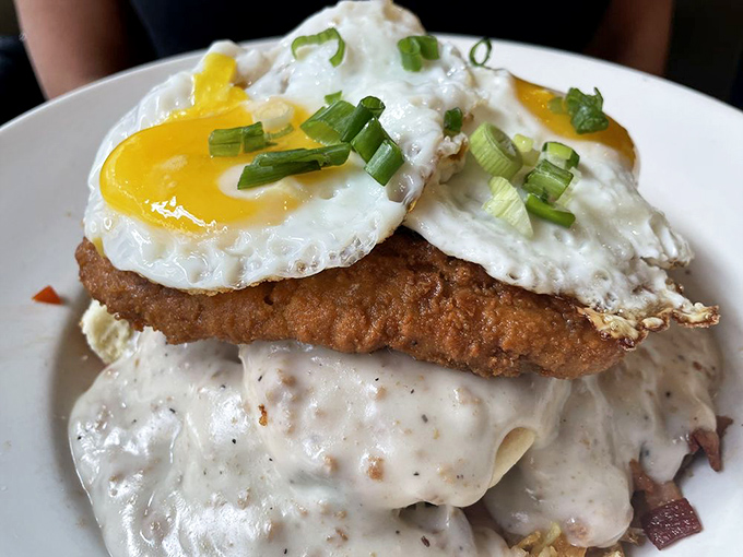 That chicken-fried steak wears its gravy blanket like a cozy Sunday morning, topped with eggs that know their supporting role.