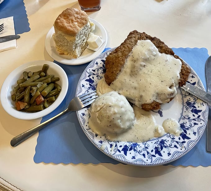Country-fried steak smothered in peppery gravy with a side of green beans&mdash;proof that happiness can indeed be served on a blue-rimmed plate.