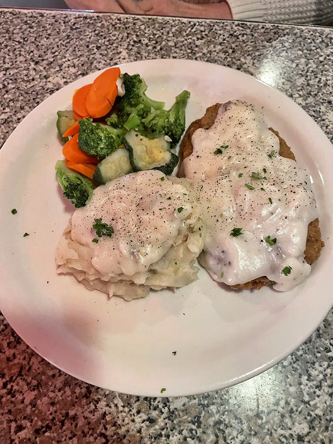 The chicken fried steak arrives like a crispy island in a sea of creamy gravy &ndash; a testament to the diner's mastery of comfort classics.