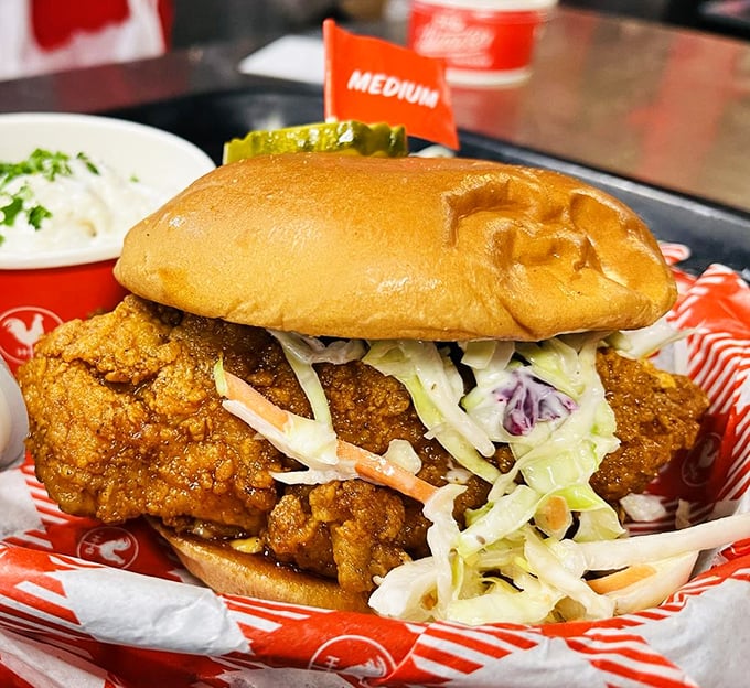 This chicken sandwich towers like a delicious skyscraper, complete with coleslaw crown and pickle foundation.