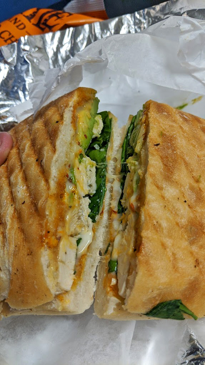 The chicken sandwich reveals its secrets when sliced&mdash;a perfect marriage of crispy exterior, juicy interior, and fresh greens that would make any lunch hour memorable.