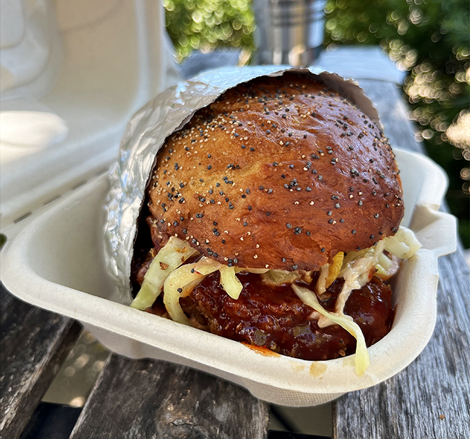 This isn't just a sandwich; it's architecture with a sesame seed roof. The glistening glaze suggests this chicken has achieved enlightenment.