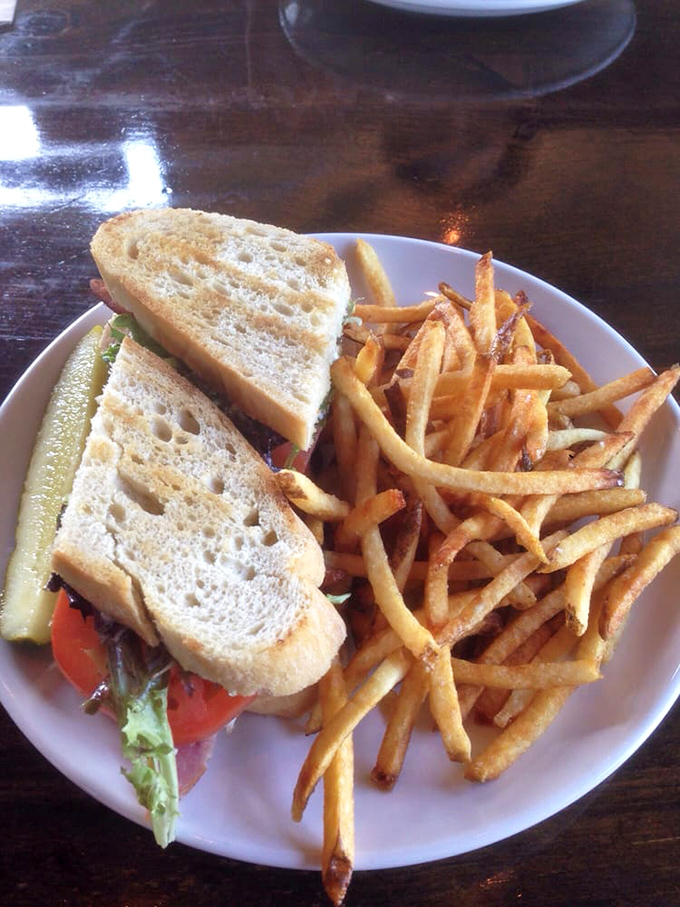 This isn't just a sandwich; it's architecture with flavor. Golden fries standing at attention beside layers of freshness between perfectly toasted sourdough.