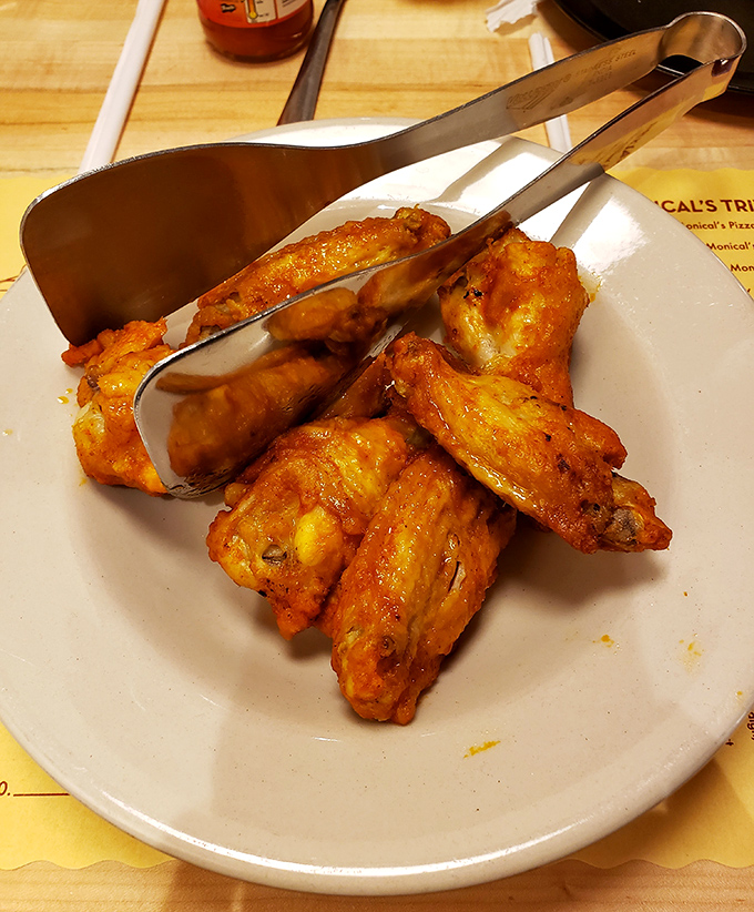 Buffalo wings done right – crispy, saucy, and demanding to be devoured before your pizza arrives. Resistance is futile.