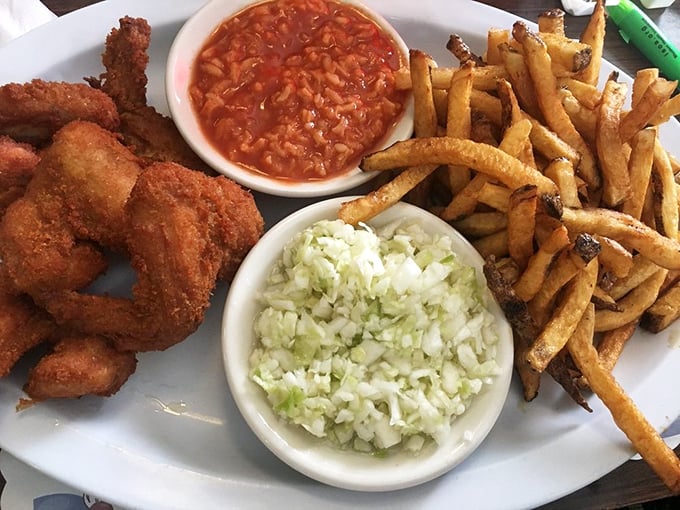 The holy trinity of Barberton dining: crispy chicken, that famous tomato-rice "hot sauce," and coleslaw that knows its purpose in life.