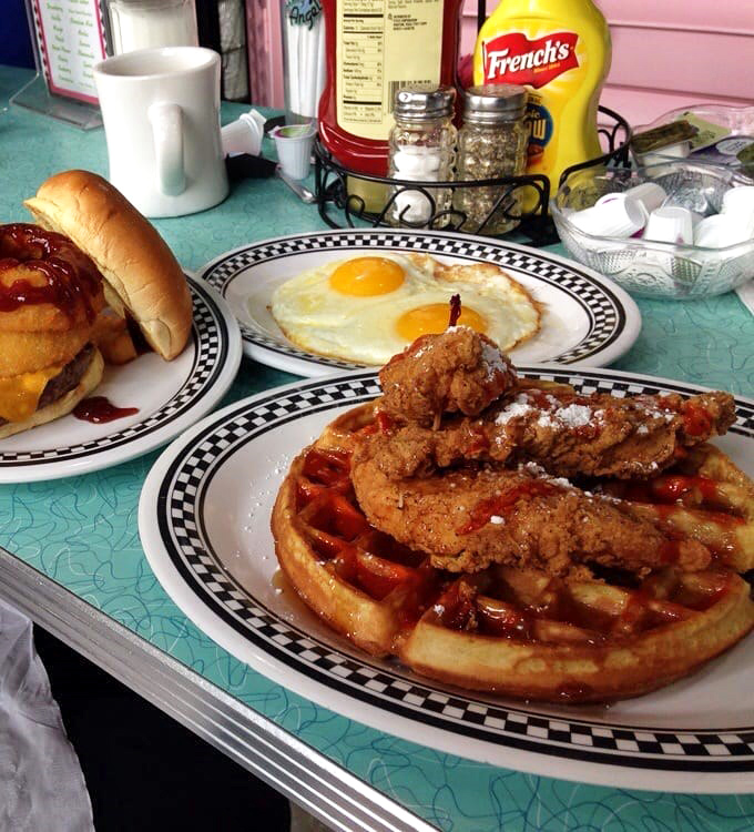 Chicken and waffles: the breakfast-lunch romance that proves opposites attract. Crispy meets sweet in this plate of comfort food perfection.