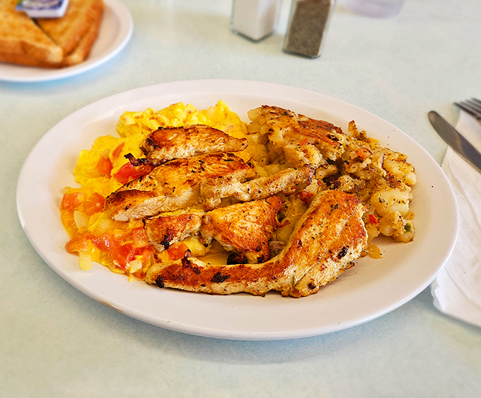 Grilled chicken nestled into fluffy eggs with perfectly saut&eacute;ed vegetables &ndash; breakfast and lunch having a delicious identity crisis.