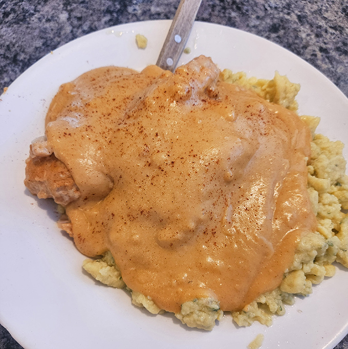 Chicken paprikash over scrambled eggs &ndash; the kind of hearty plate that makes you want to adopt a Hungarian grandmother immediately.