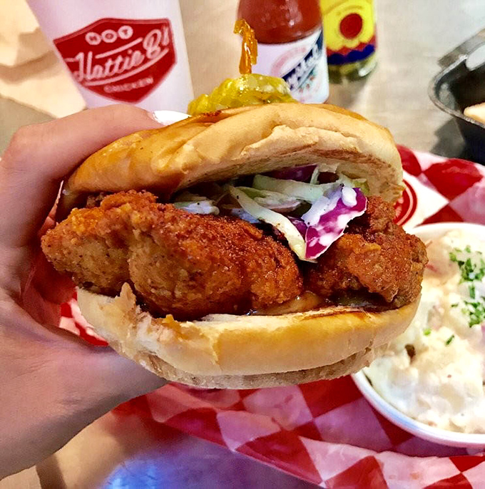 The hot chicken sandwich: where crispy, spicy perfection meets soft bun in a handheld masterpiece that's worth every napkin you'll need.