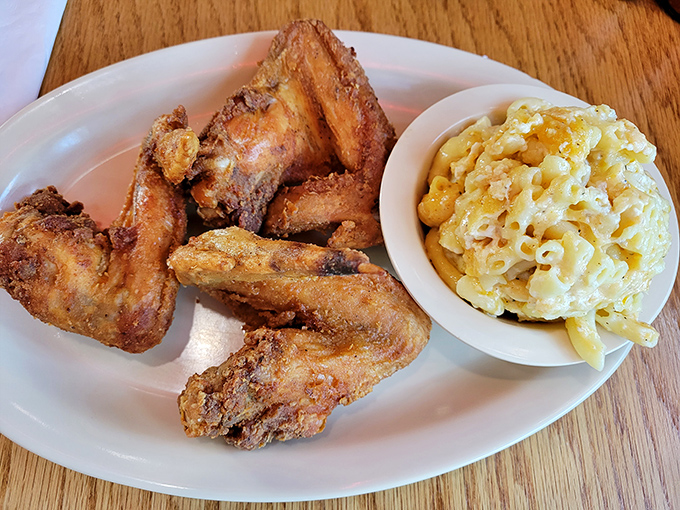 Wings so perfectly fried they deserve their own theme music, alongside mac & cheese that's clearly been taking its vitamins.