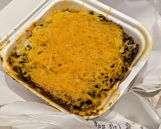 The legendary 5-way in its to-go glory—spaghetti, chili, beans, onions, and that signature mountain of cheese that's practically a food group here.