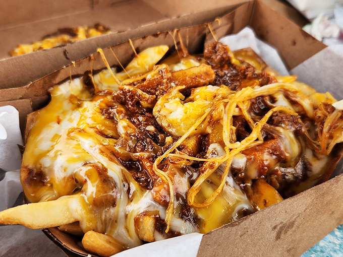 Chili cheese fries that laugh in the face of diet culture. This glorious mess of cheese, chili, and potatoes is what comfort food dreams are made of.