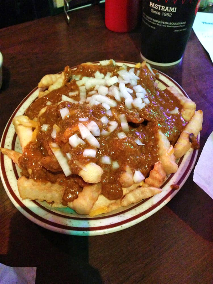 Chili fries that laugh in the face of diet culture. The raw onions add a sharp counterpoint to the rich, beefy chili&mdash;pure comfort on a plate.