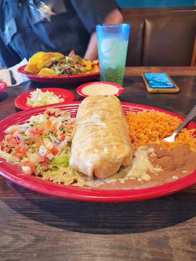 Chimichangas that could make a grown adult weep with joy, served on a fiery red plate that matches the passion in every bite.