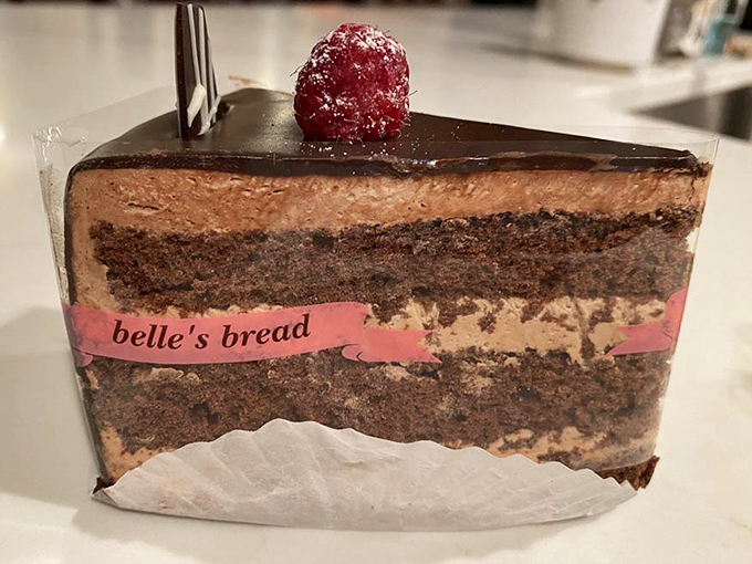 Layer upon layer of chocolate decadence, with Belle's signature pink band &ndash; this cake isn't just dessert, it's an architectural achievement.