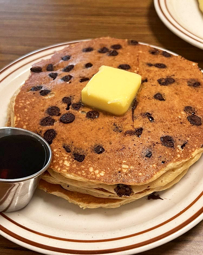 Chocolate chip pancakes that make you question why you ever considered "being good" today. The butter melts like your willpower when they arrive.