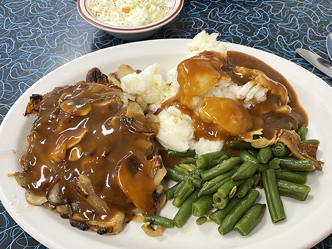 Comfort food perfection: chopped sirloin smothered in mushroom gravy alongside mashed potatoes and green beans. Grandma would approve&mdash;and maybe be a little jealous.