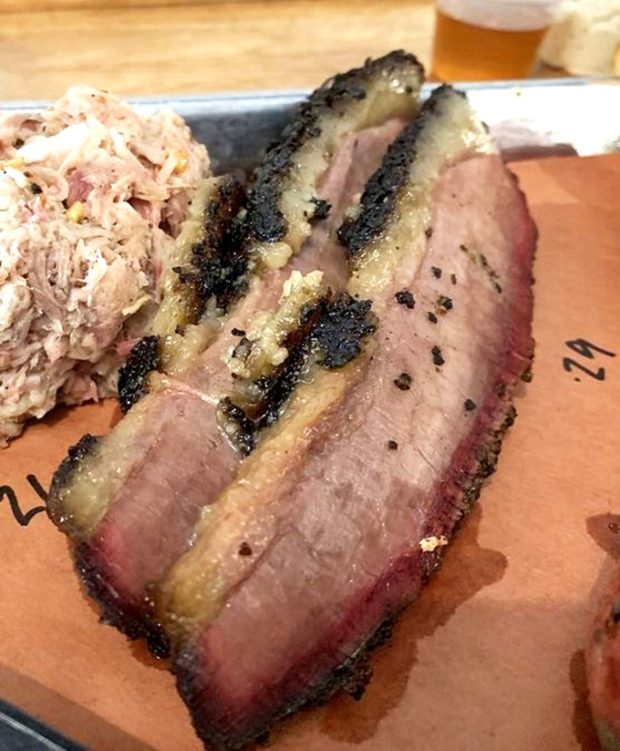 This isn't your average chopped pork &ndash; it's barbecue artistry on a plate, with that telltale pink smoke ring of excellence.
