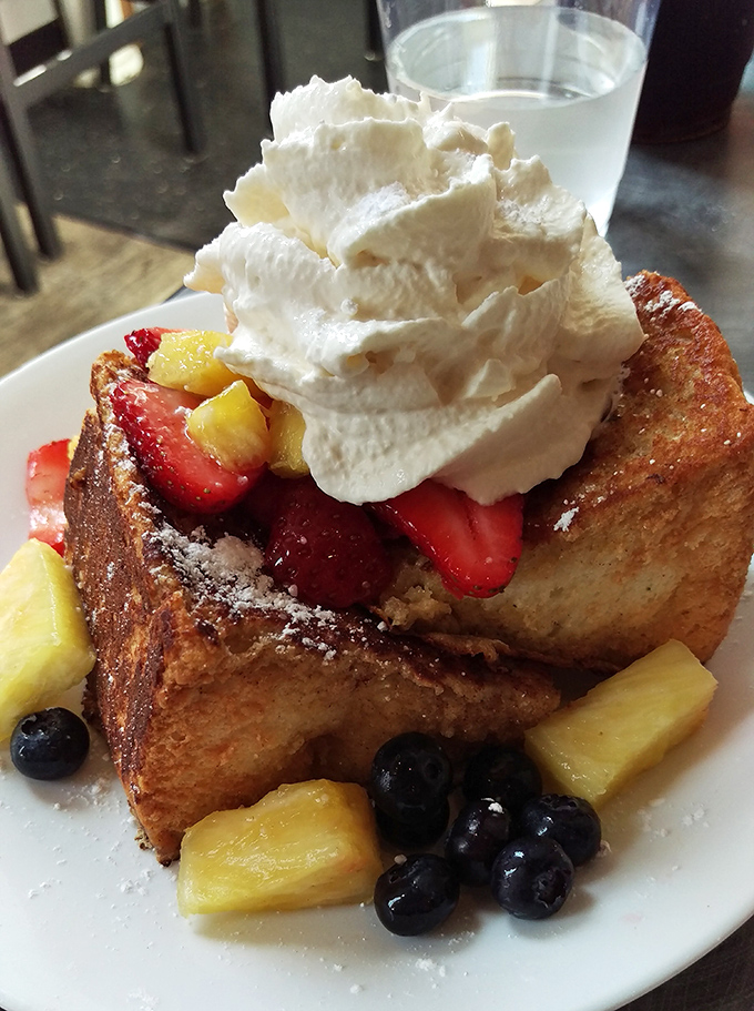 French toast that's having an identity crisis as a tropical vacation. Strawberries, pineapple, and whipped cream turn breakfast into a celebration.