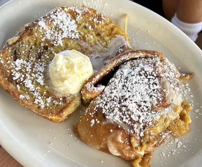 French toast that makes ordinary bread weep with jealousy. That dollop of butter melting into powdered sugar perfection is breakfast's glamour shot.