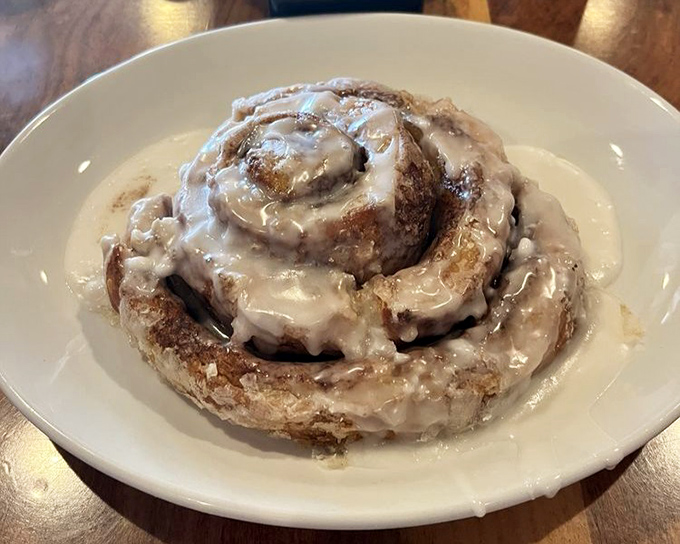 This isn't just a cinnamon roll&mdash;it's a spiral-bound love letter to morning indulgence. Pillowy dough, cinnamon swirls, and cream cheese glaze creating breakfast nirvana.
