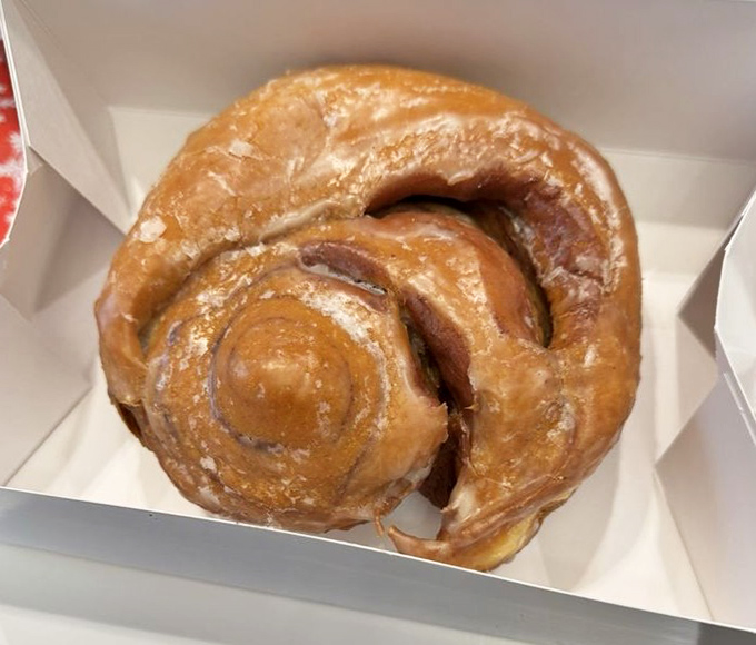 This cinnamon roll isn't just breakfast; it's an architectural marvel of swirls, glaze, and morning happiness.