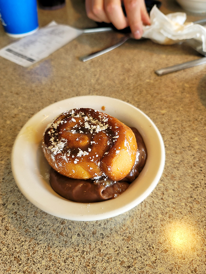 Dessert nirvana in its simplest form: a warm cinnamon roll swimming in chocolate sauce. Diet plans come here to die happy.