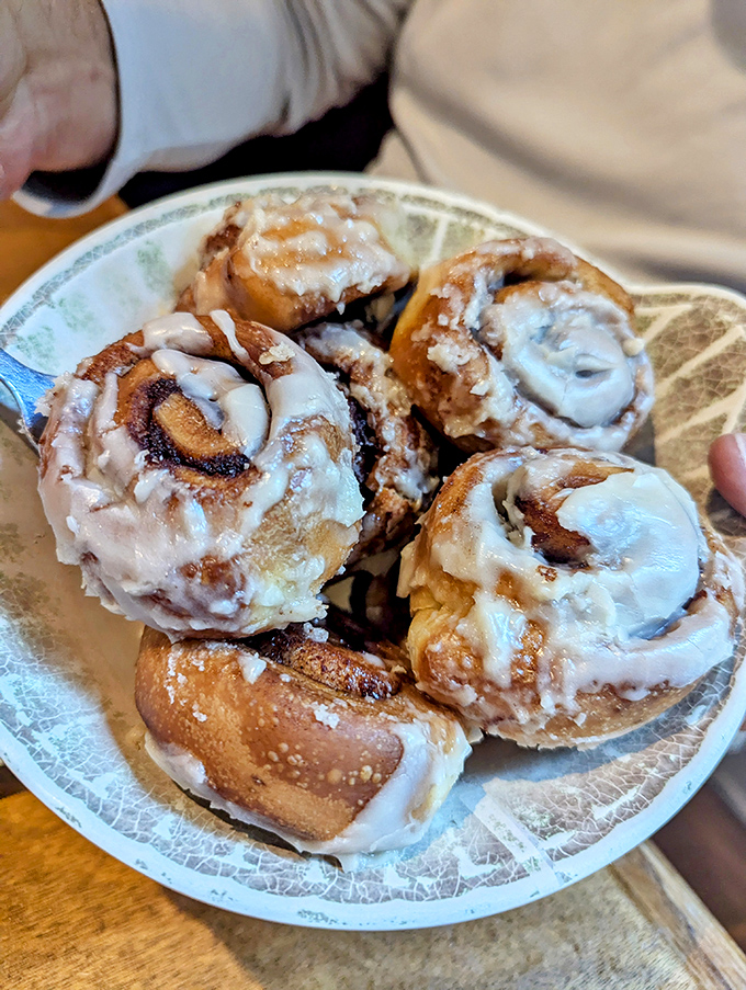Cinnamon rolls that could make a pastry chef blush—spiral-shaped proof that sometimes the best things in life come in sticky, glazed packages.